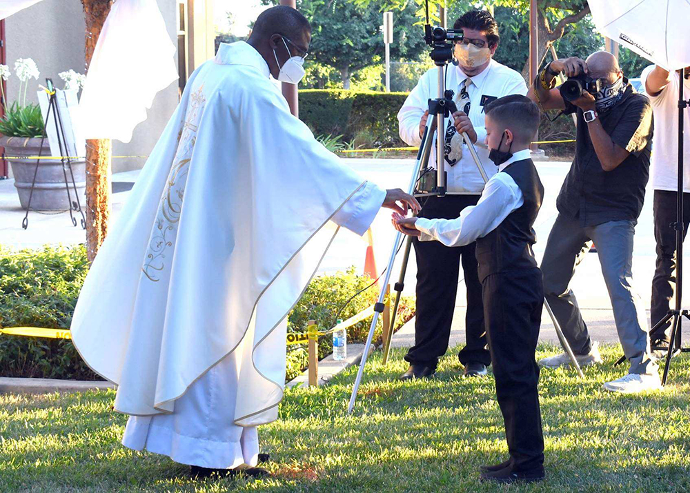 Under tents and with folding chairs, Catholics resume First Communions ...